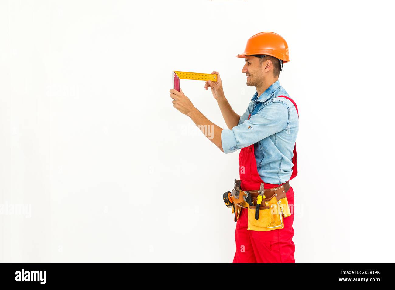 Construction worker pulling a rope. Full length studio shot isolated on ...