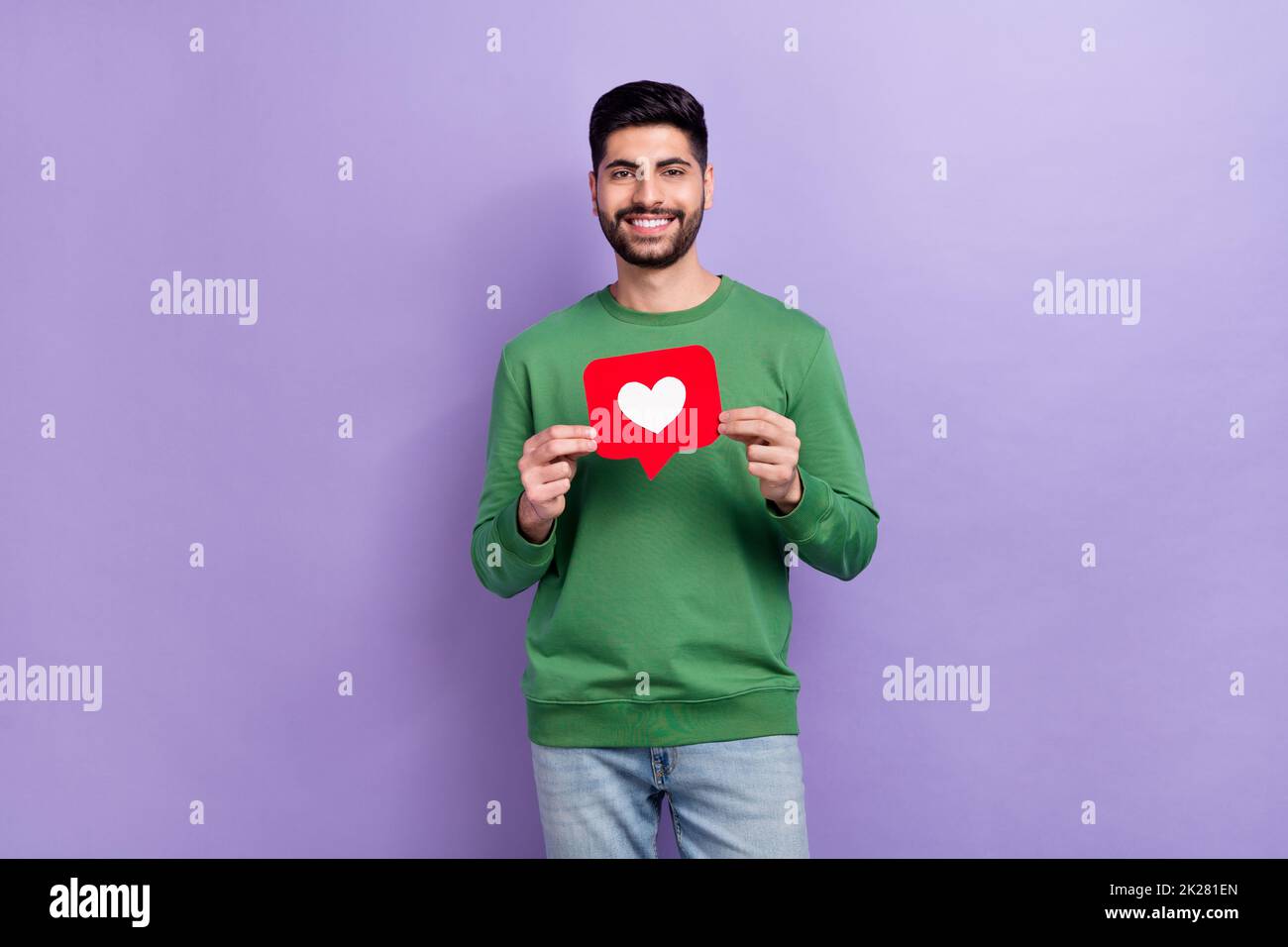 Photo of cheerful positive good mood man dressed green pullover hold ...