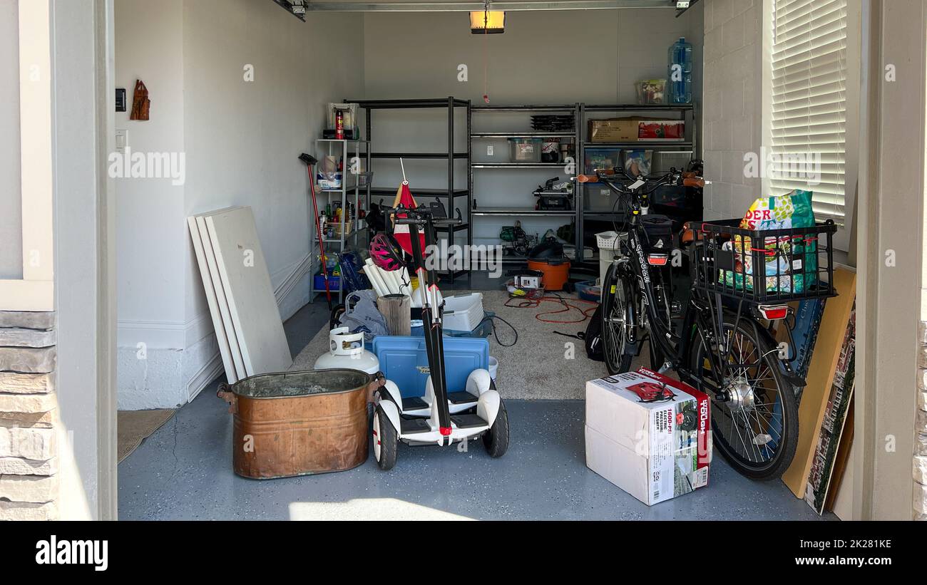 Orlando, FL USA - March 3, 2022: An unorganized garage filled with a ...