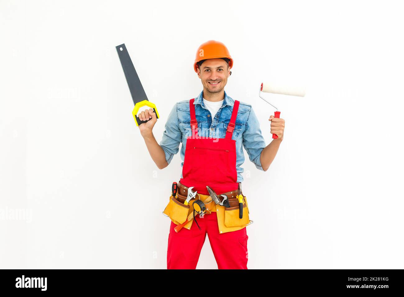 young friendly crouch manual worker isolated on white Stock Photo - Alamy