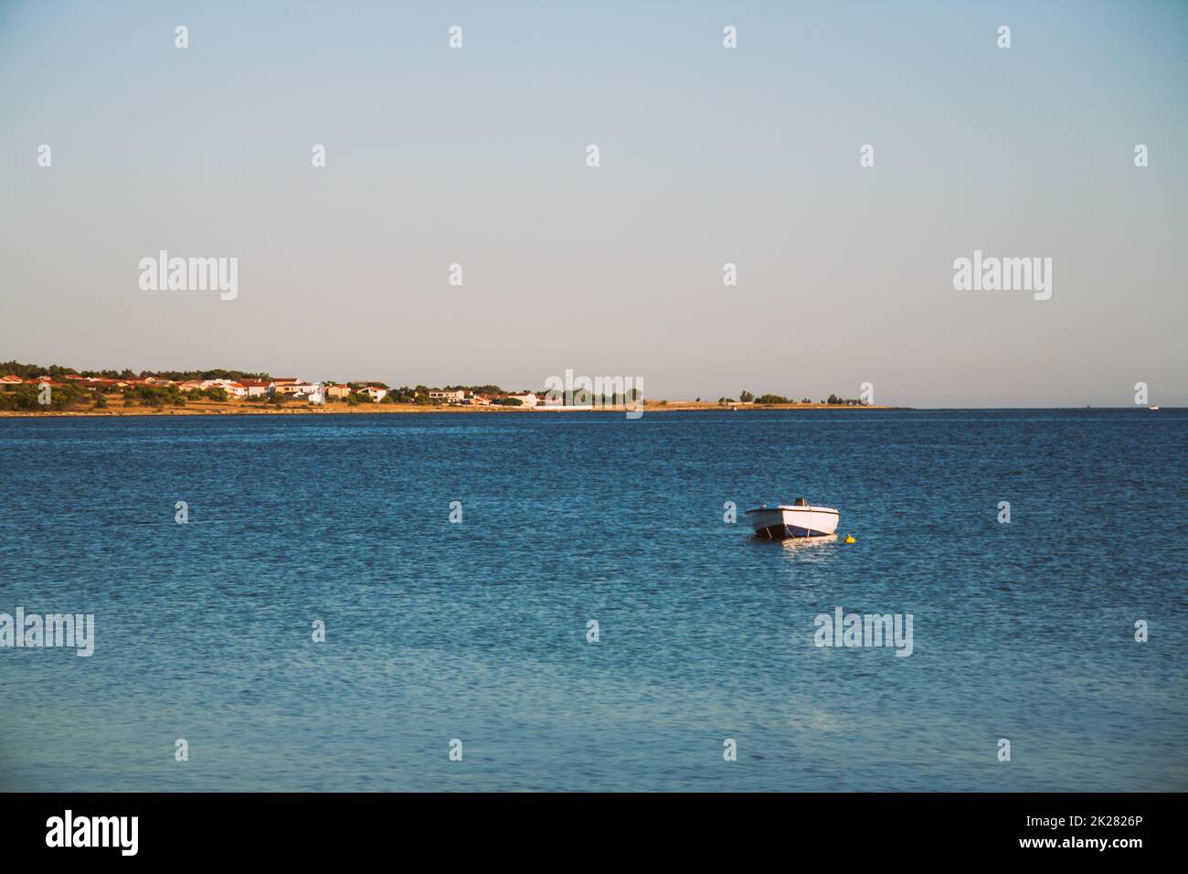 Small fishing boat moored on a sea Stock Photo - Alamy