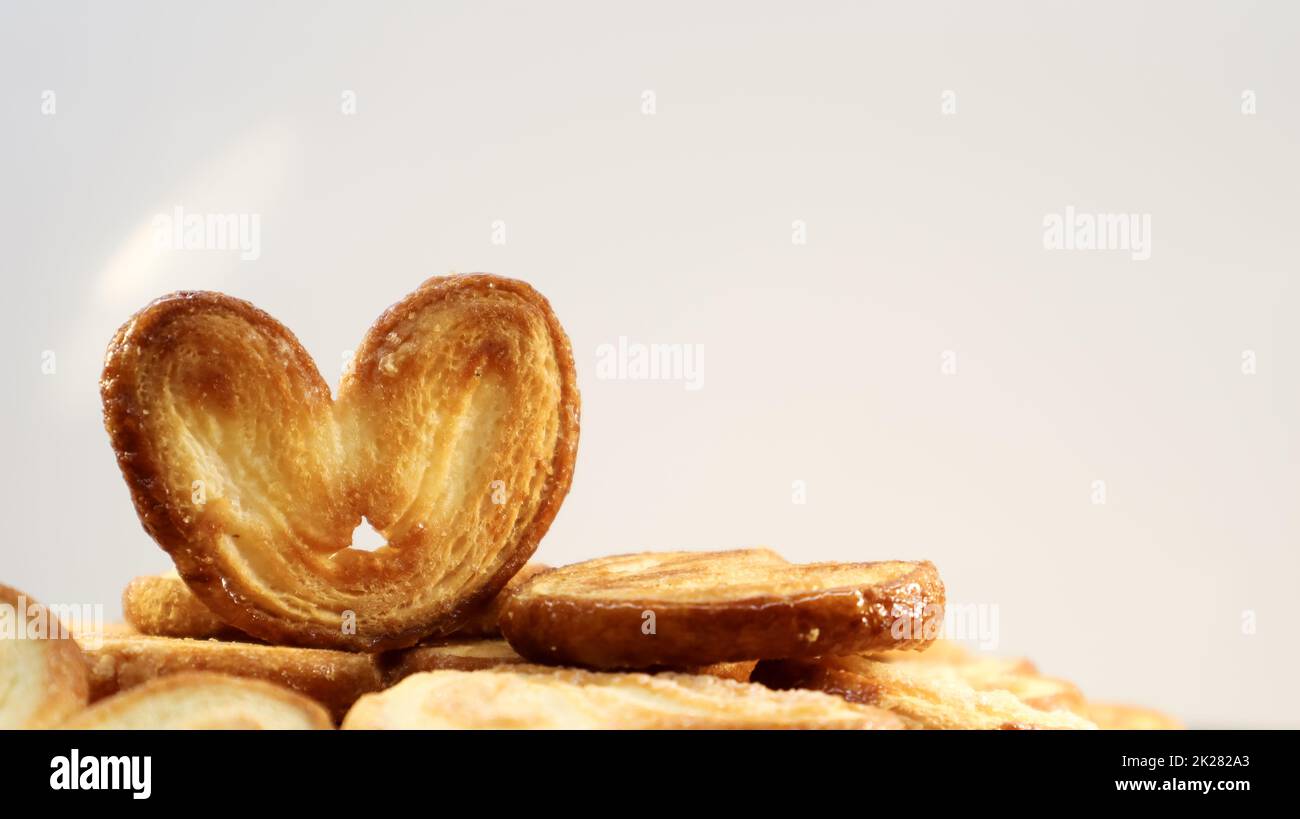 Fresh puff pastry palm cookies in the shape of a heart. Classic French ...