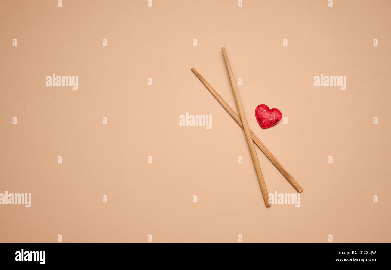 two wooden chopsticks on a brown background, copy space Stock Photo - Alamy