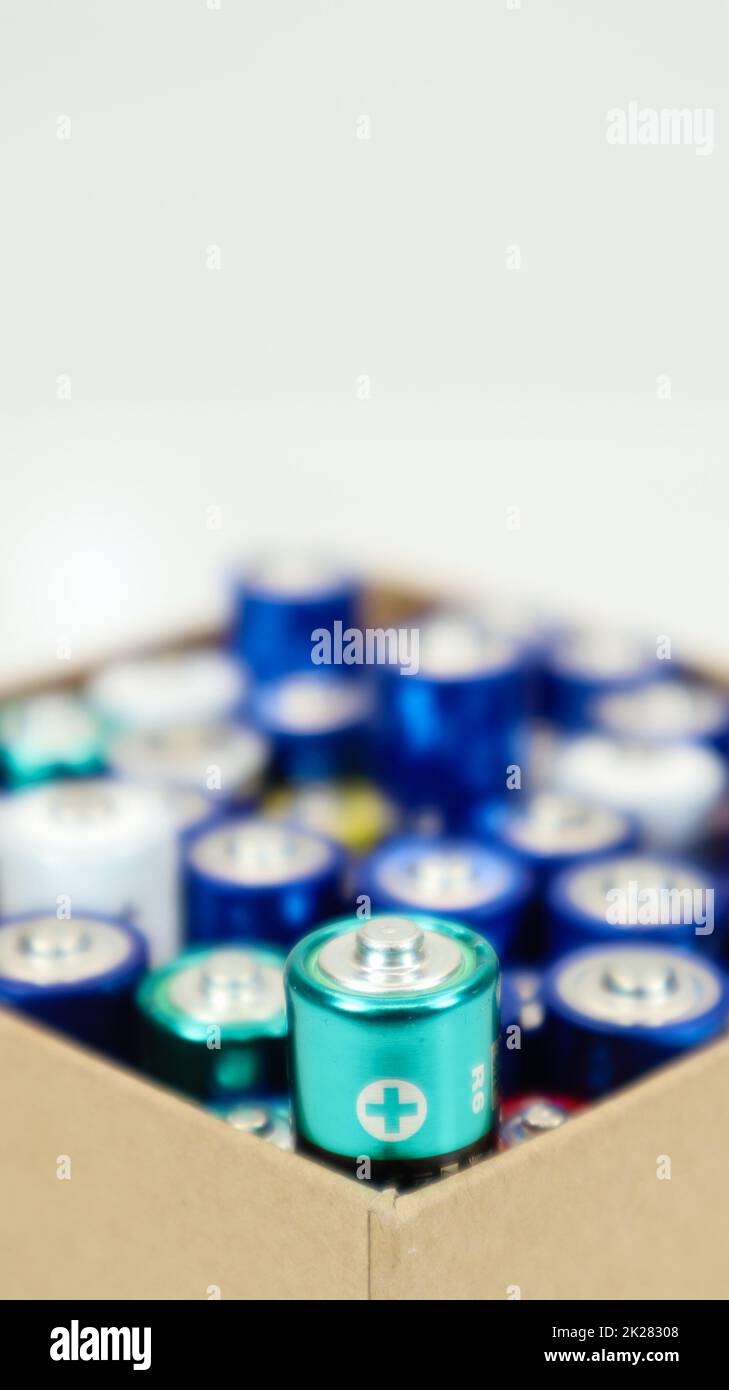 A cardboard box on a white background full of used household AA, AAA ...