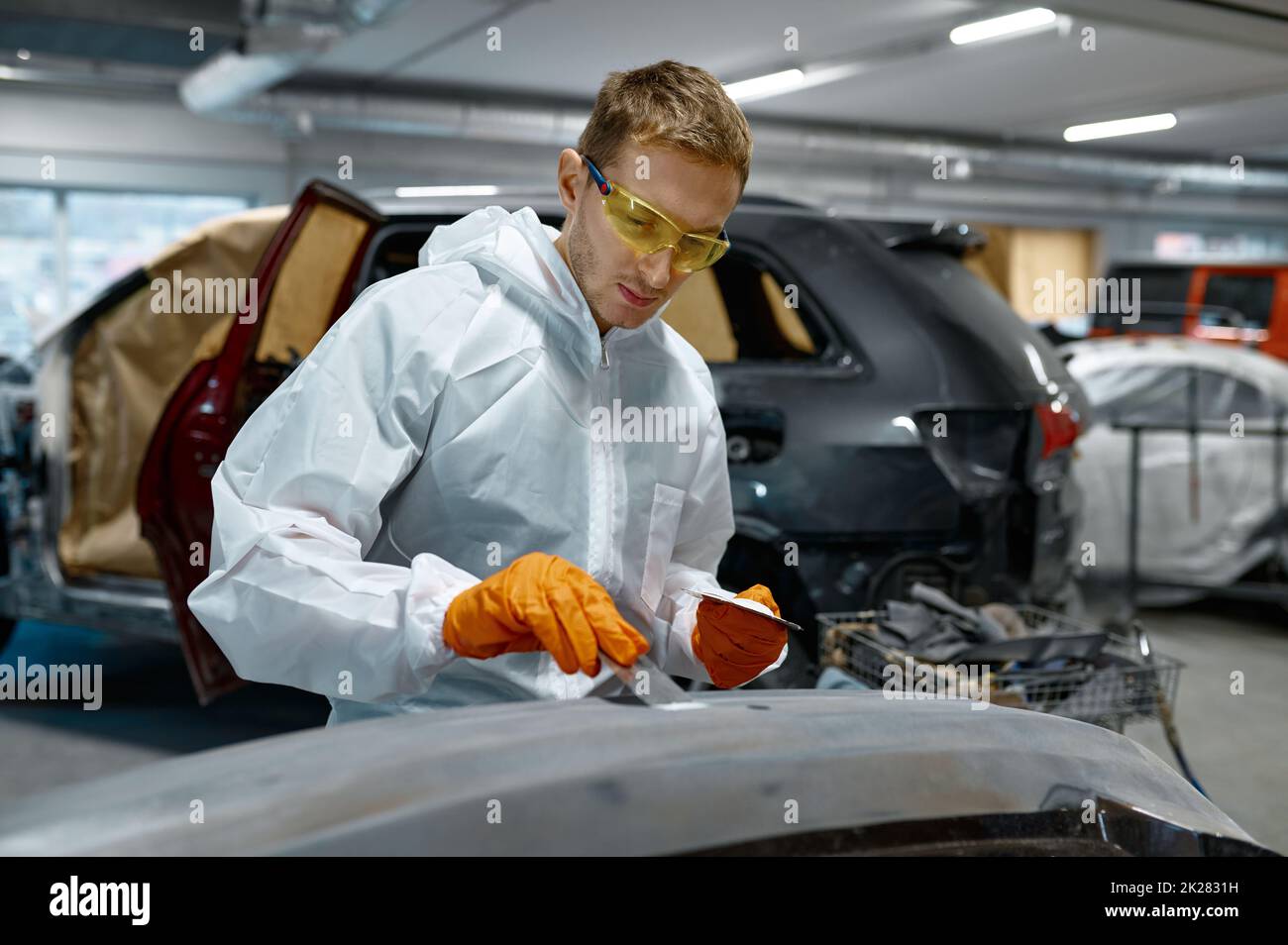Mechanic engaged in local repairing car body Stock Photo - Alamy