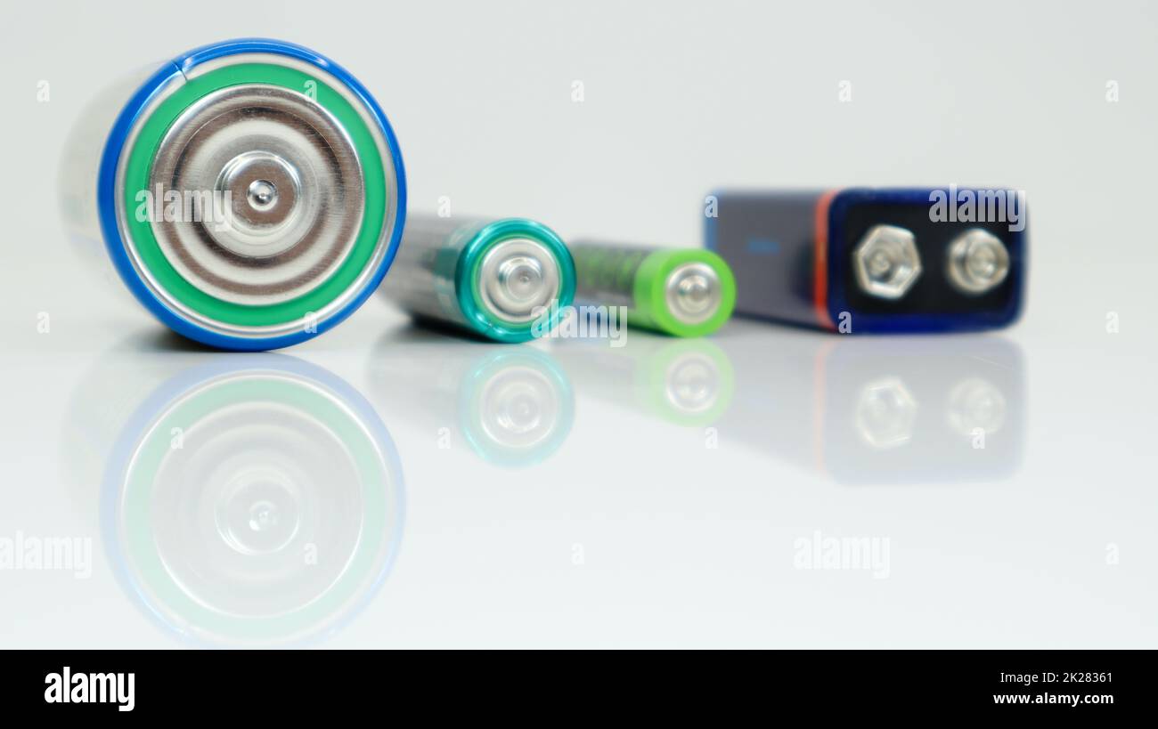 Battery type D or C, PP3, AA, AAA on a white background with reflection ...