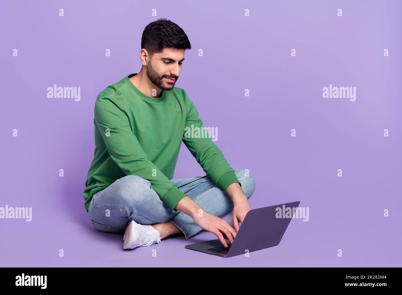 Full body photo of young hispanic guy sit floor crossed legs chatting ...