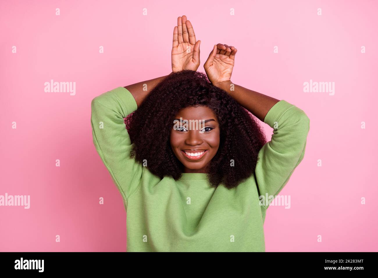 Photo of adorable pretty lady wear green sweater showing arms rabbit ...