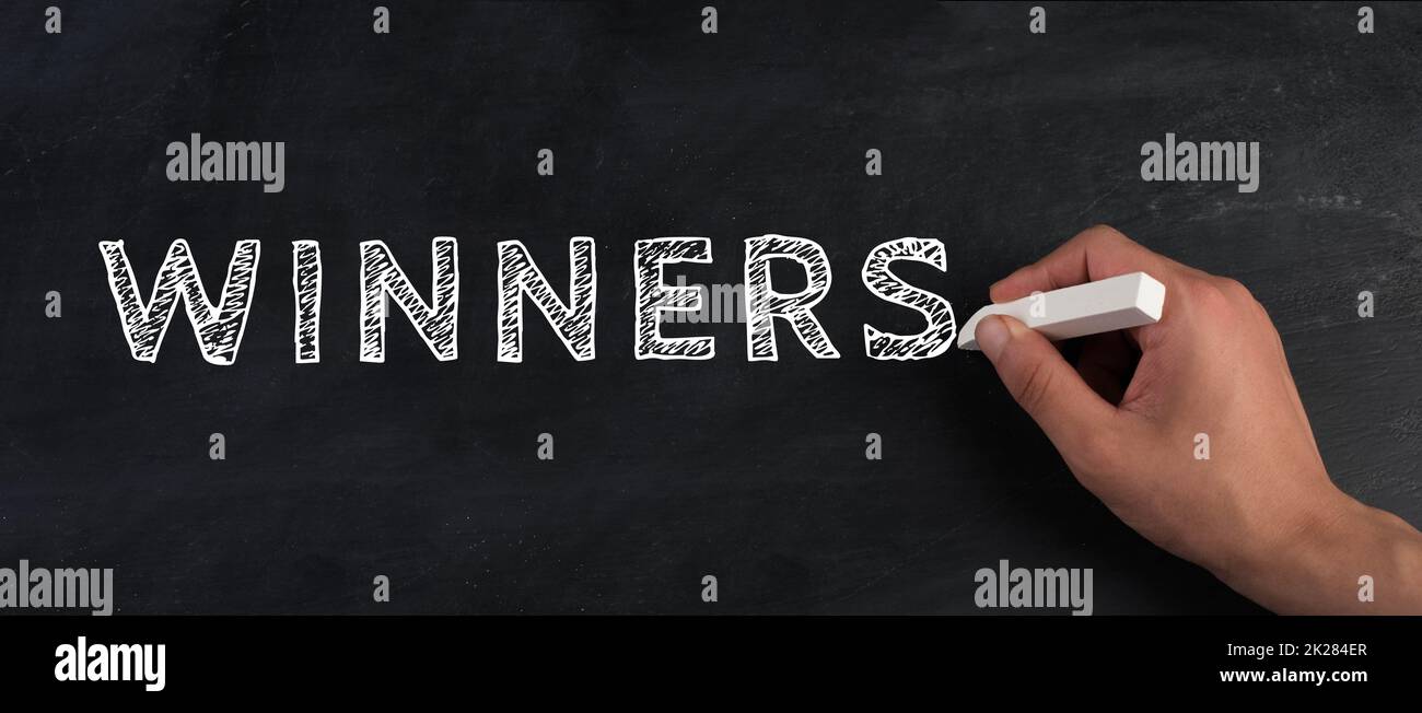 The word winner is written on a chalkboard, achievement in business ...