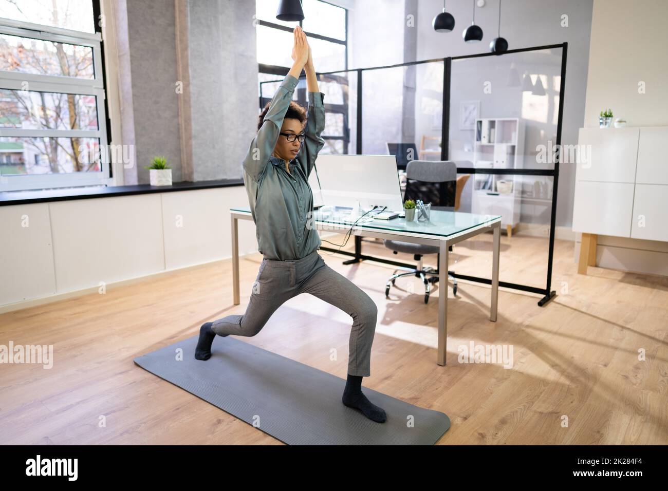 African American Employee Doing Split Squat Stock Photo - Alamy