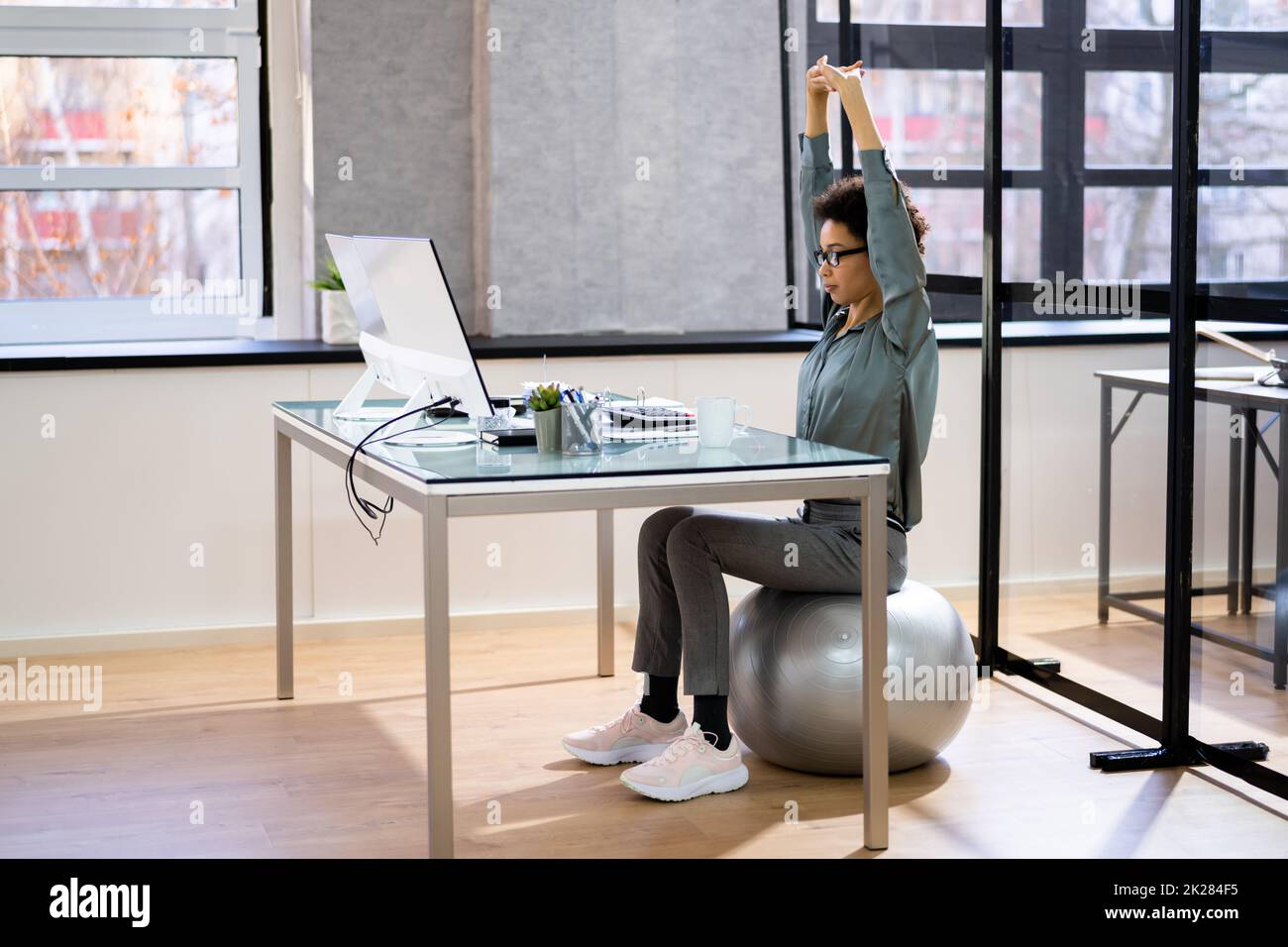 Female office using exercise ball hi-res stock photography and images ...