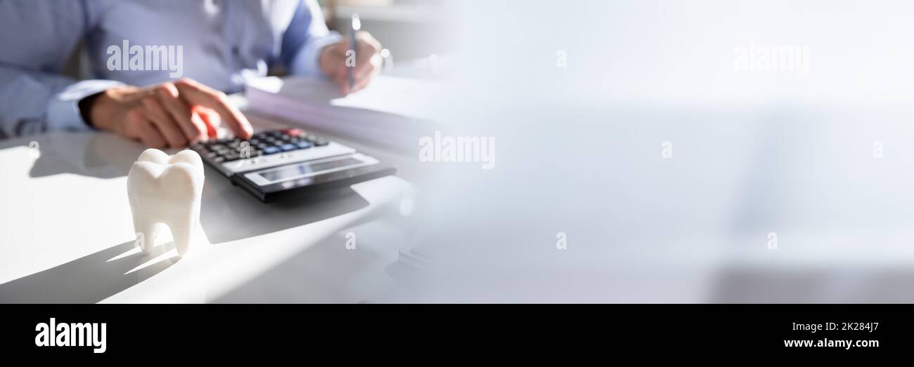 Tooth In Front Of Businessperson Calculating Bill Stock Photo - Alamy
