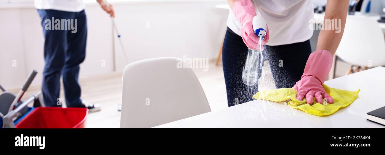 Two Young Janitor Cleaning The Office Stock Photo - Alamy