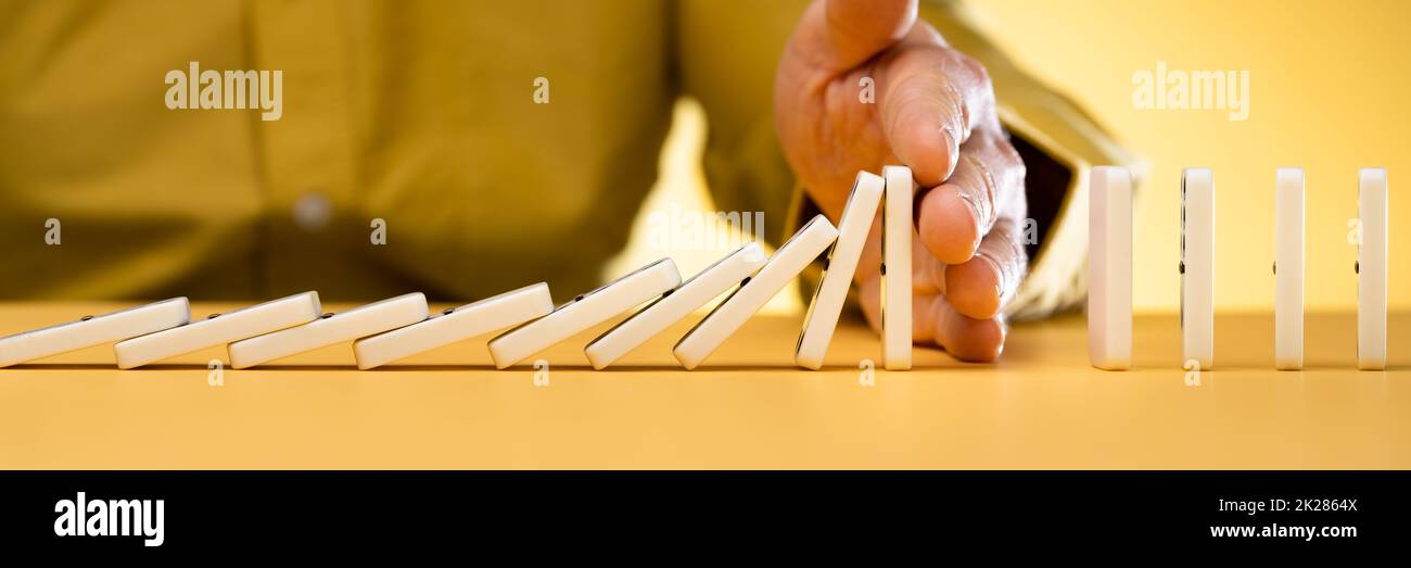 Falling Domino Stop. Fall Prevention Stock Photo - Alamy