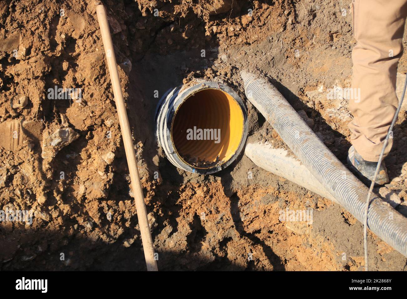 Supply line in an excavation pit Stock Photo - Alamy