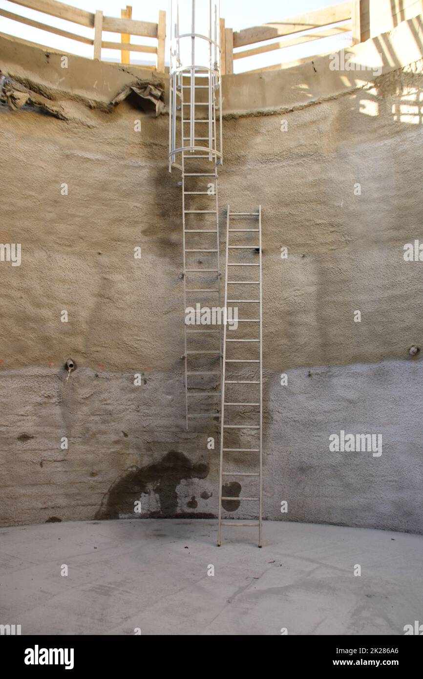 Ladder leading up from a pit Stock Photo - Alamy