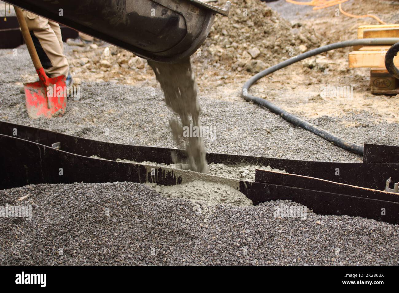 Filling a strip foundation with liquid concrete Stock Photo - Alamy