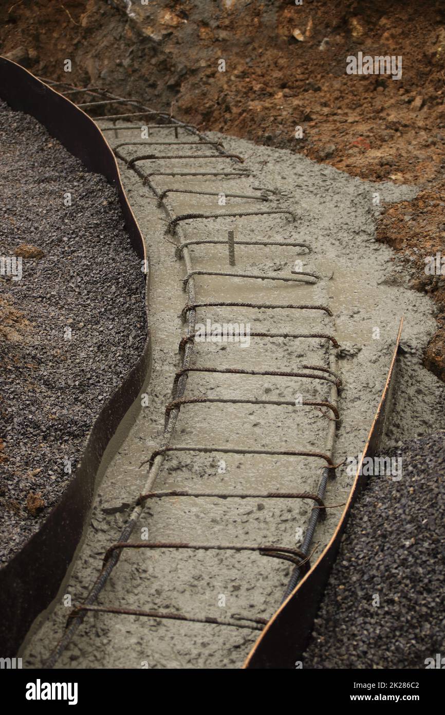 Filling a strip foundation with liquid concrete Stock Photo - Alamy