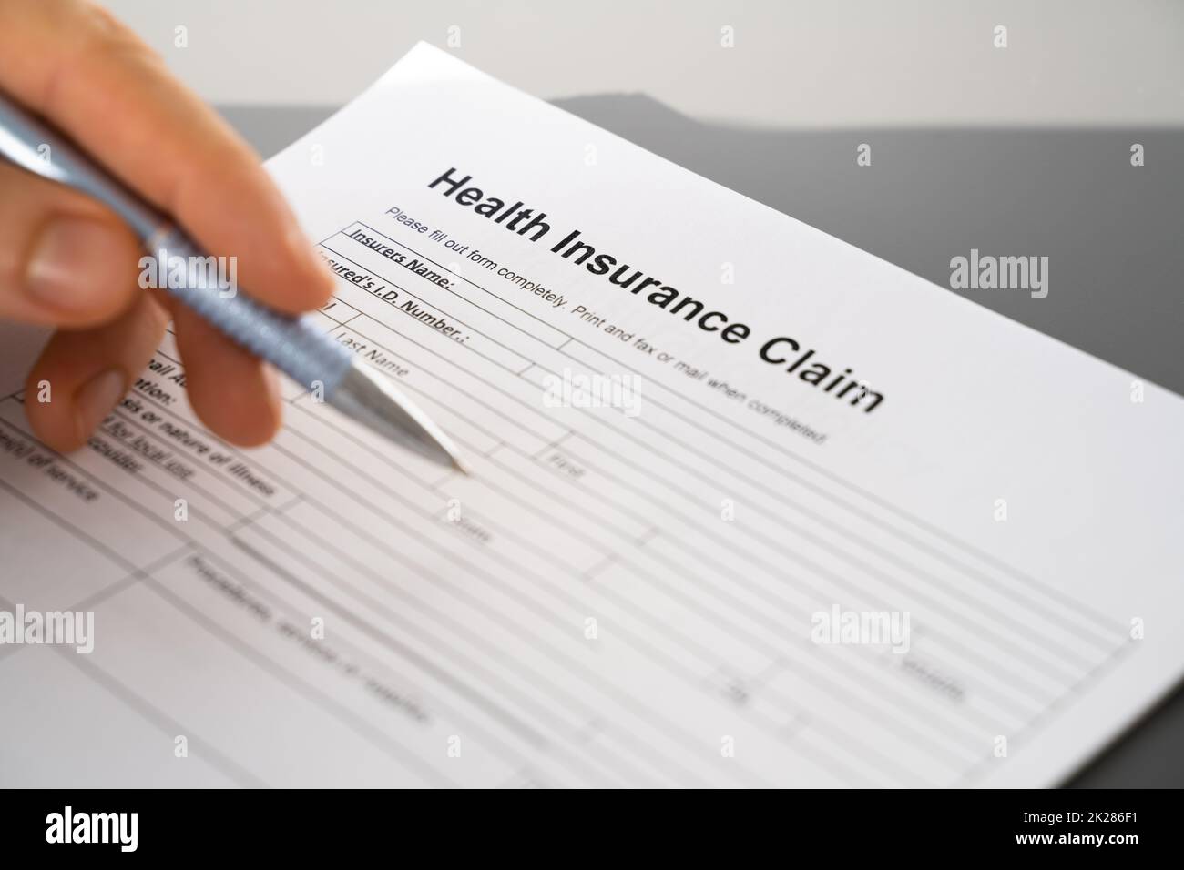 Hand Filling Health Insurance Claim Form Stock Photo - Alamy