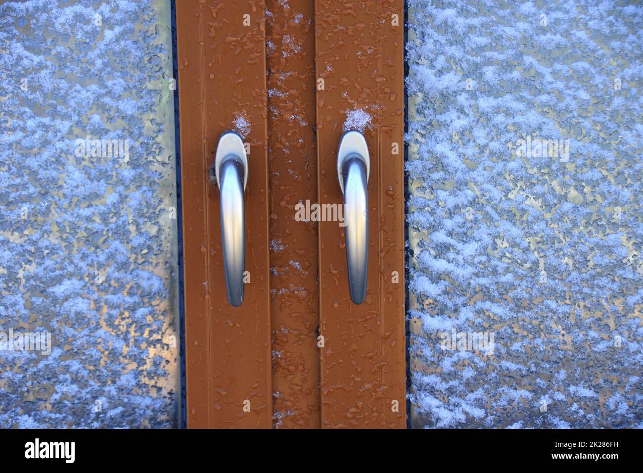 Window is covered with snow from the inside through a hole in the roof ...