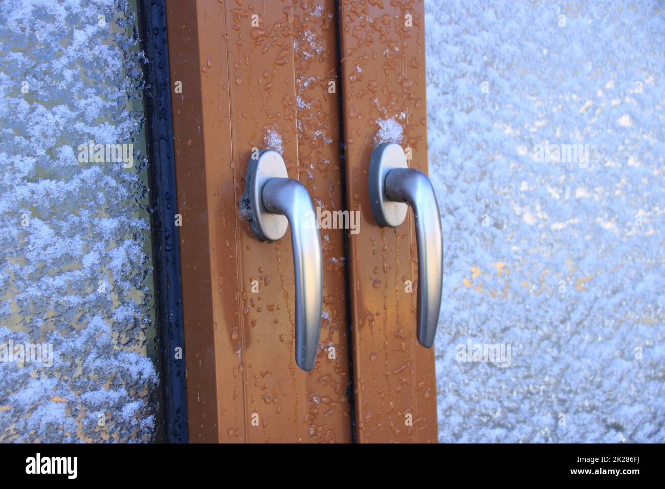 Window is covered with snow from the inside through a hole in the roof ...