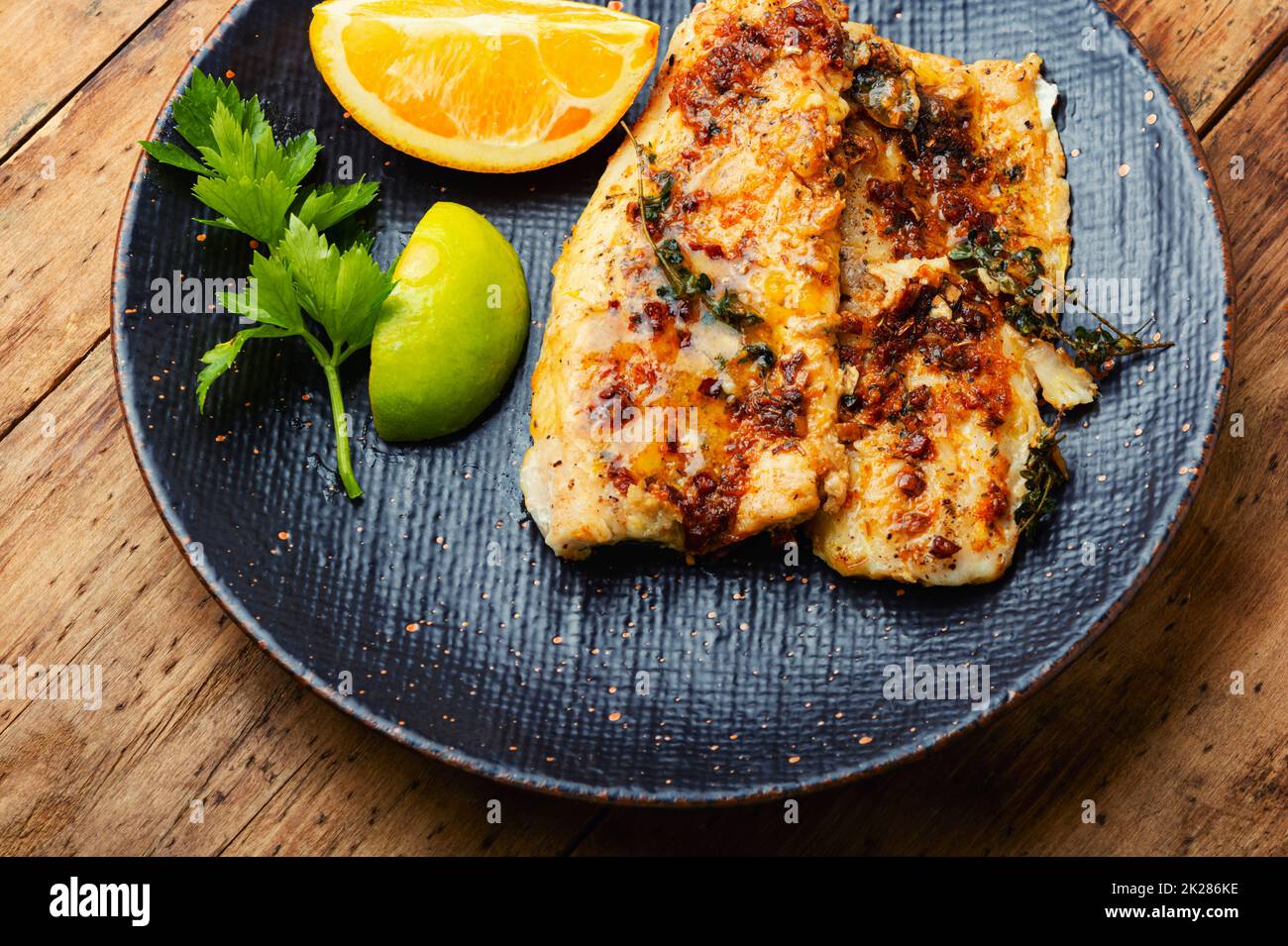 Fried fish fillets in orange oil Stock Photo - Alamy