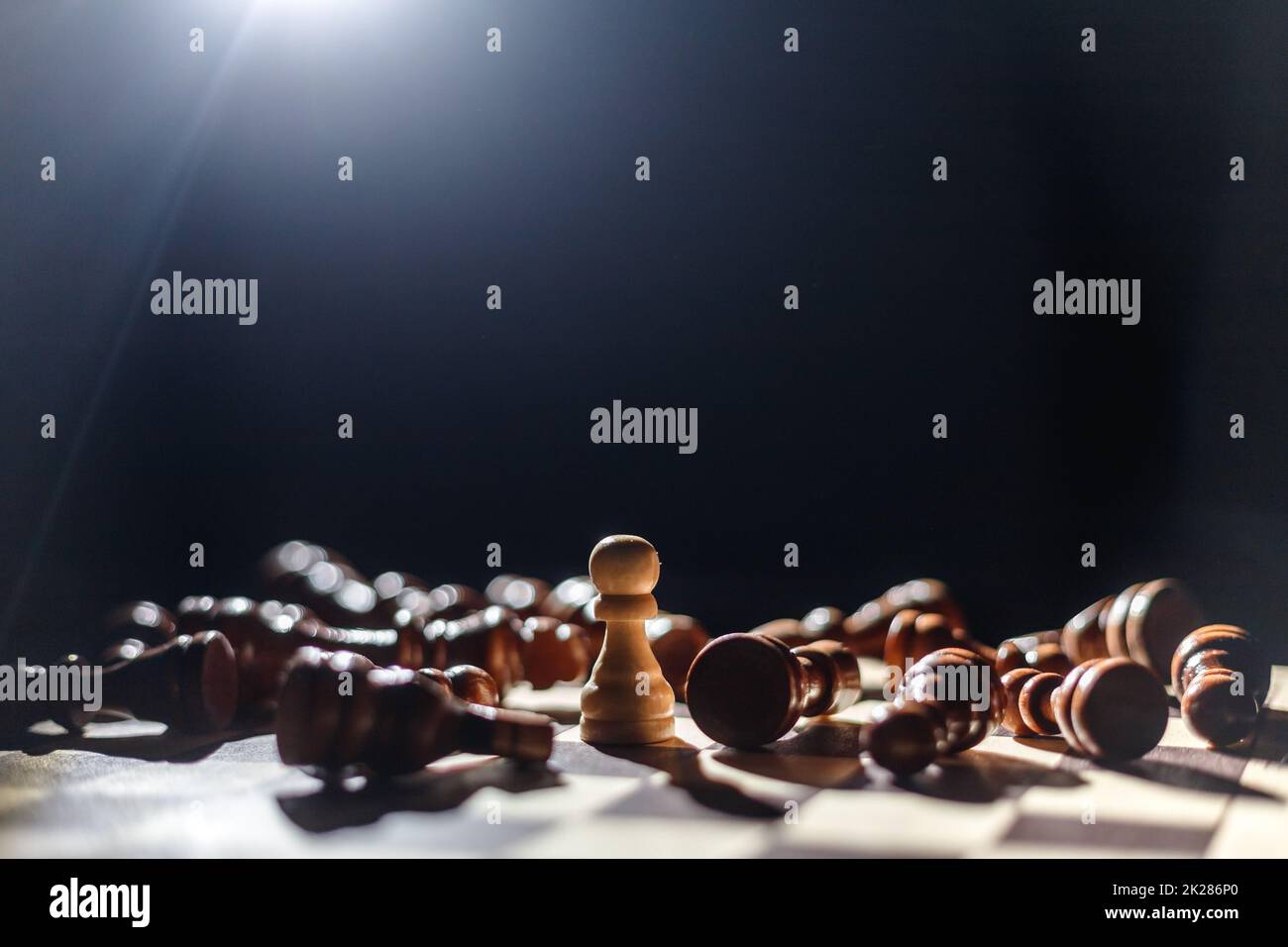 Winner white pawn surrounded by lying black chess. Leadership, strength ...