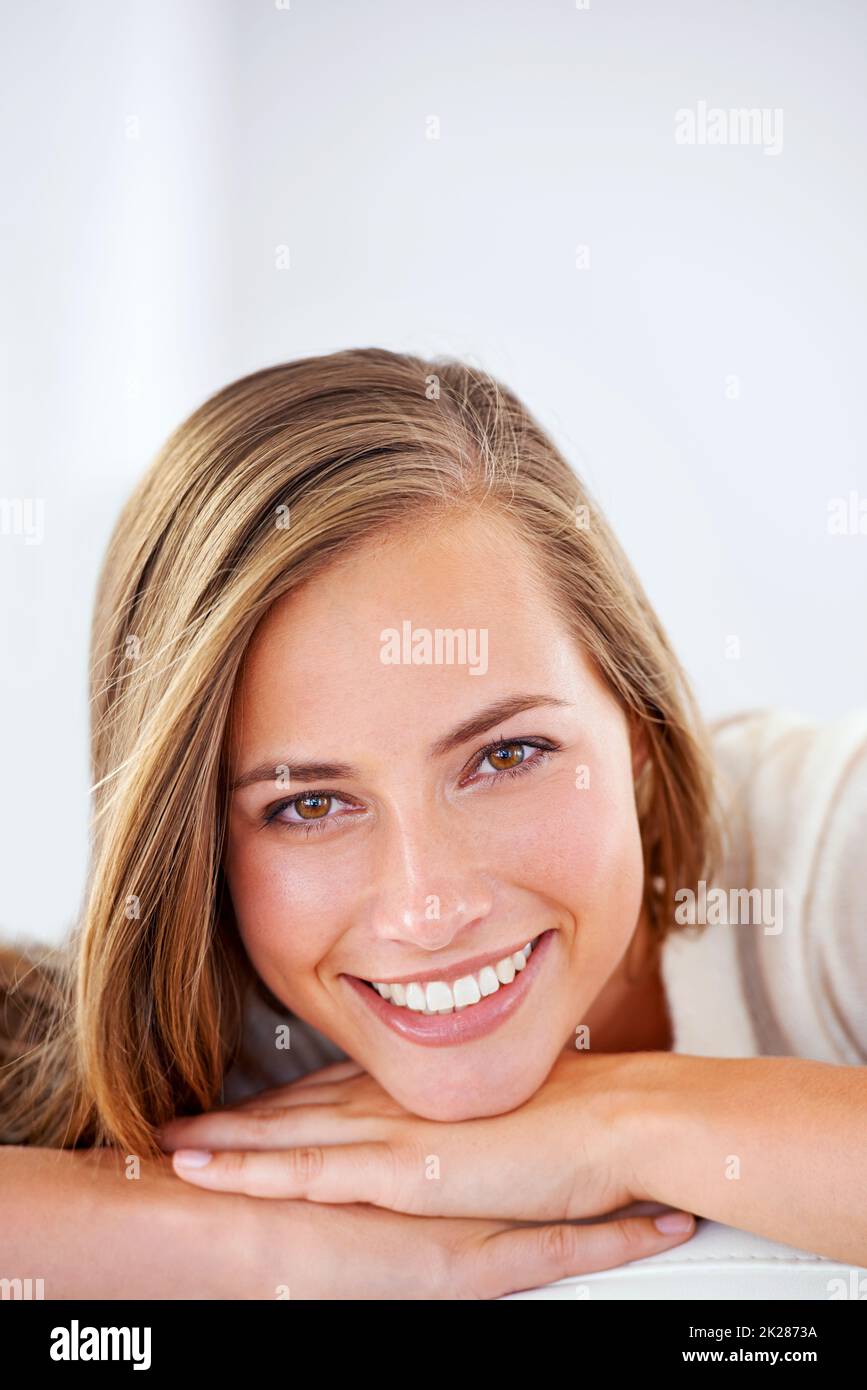 Happy at home. Portrait of an attractive young woman resting her head ...