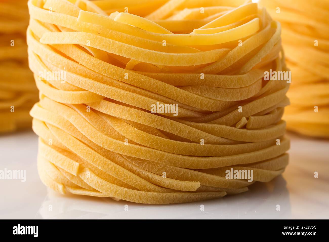 dried italian pasta, fettuccine nests Stock Photo - Alamy