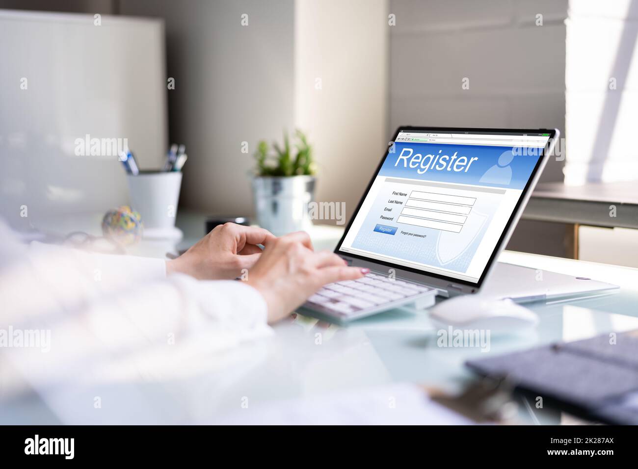 Businesswoman's Hand Filling Online Registration Form Stock Photo - Alamy