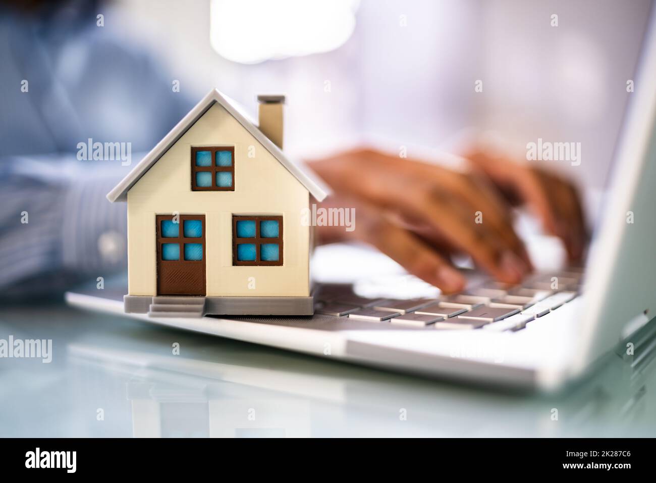 Real Estate House Model Near Laptop Stock Photo - Alamy