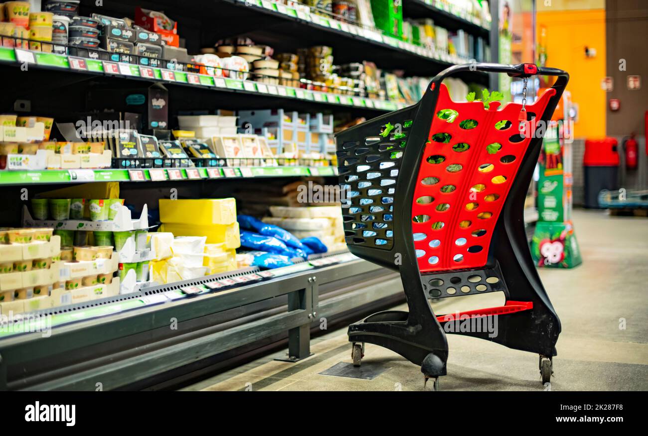 A shopping cart with grocery products in a supermarket Stock Photo - Alamy