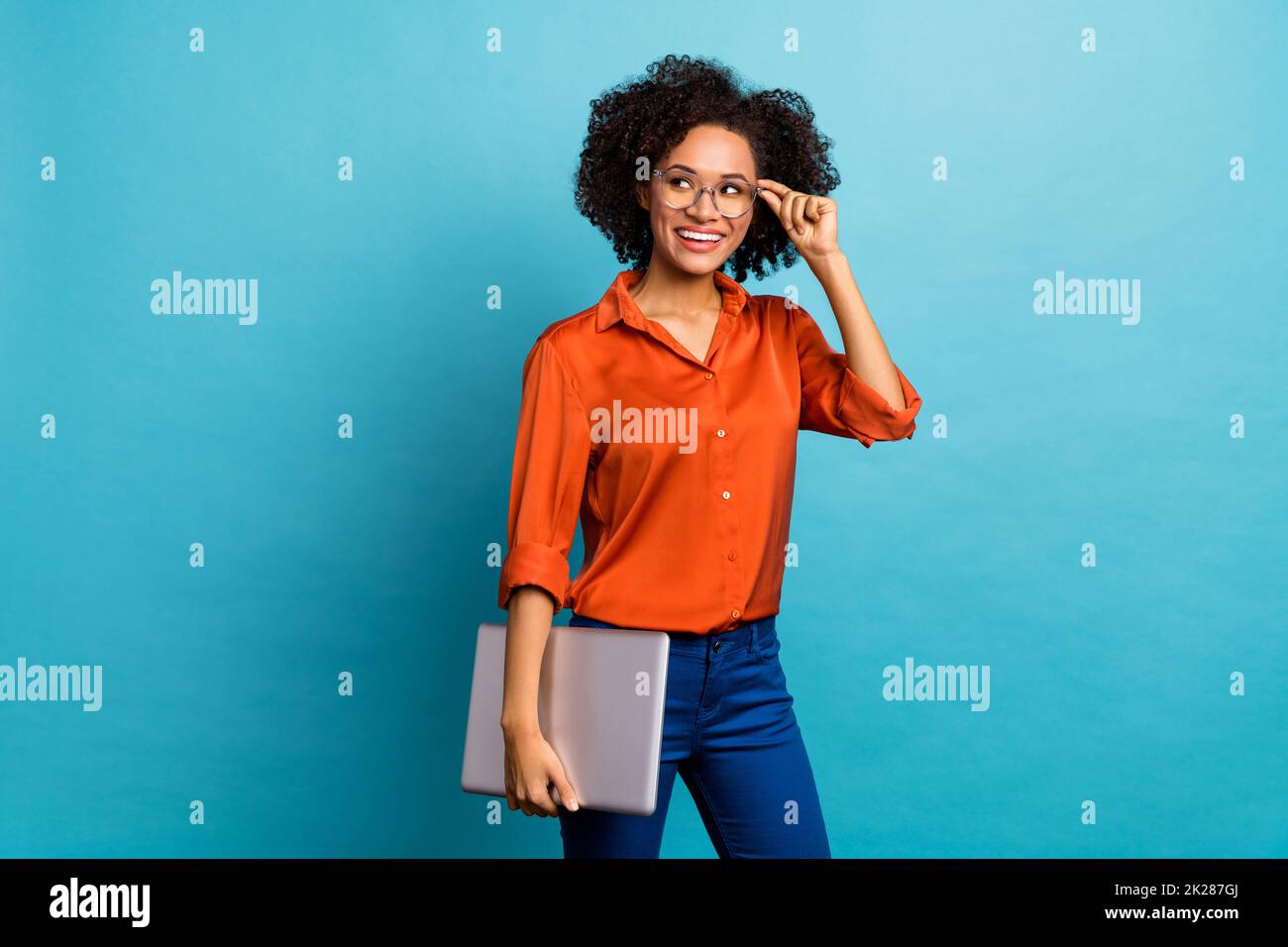 Portrait of beautiful trendy cheerful pensive girl holding laptop ...