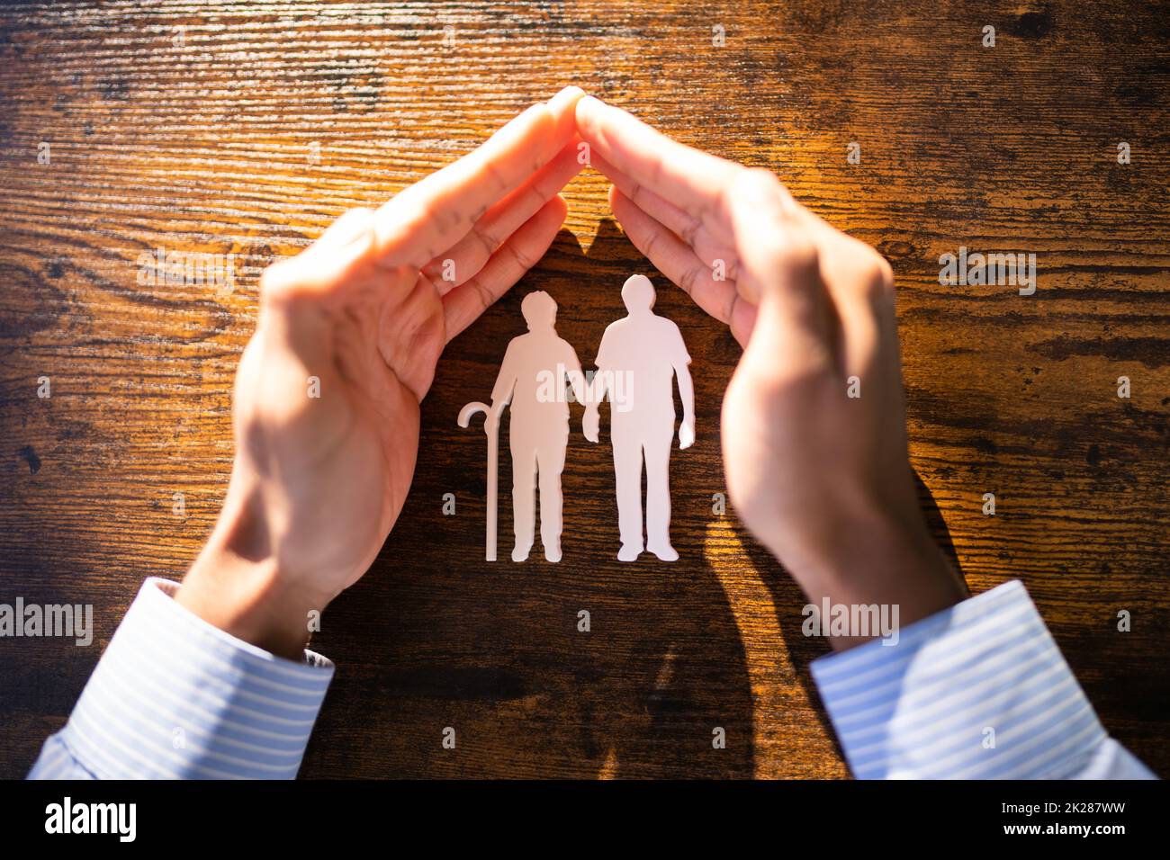 African American Hand Protecting Senior Couple Stock Photo - Alamy