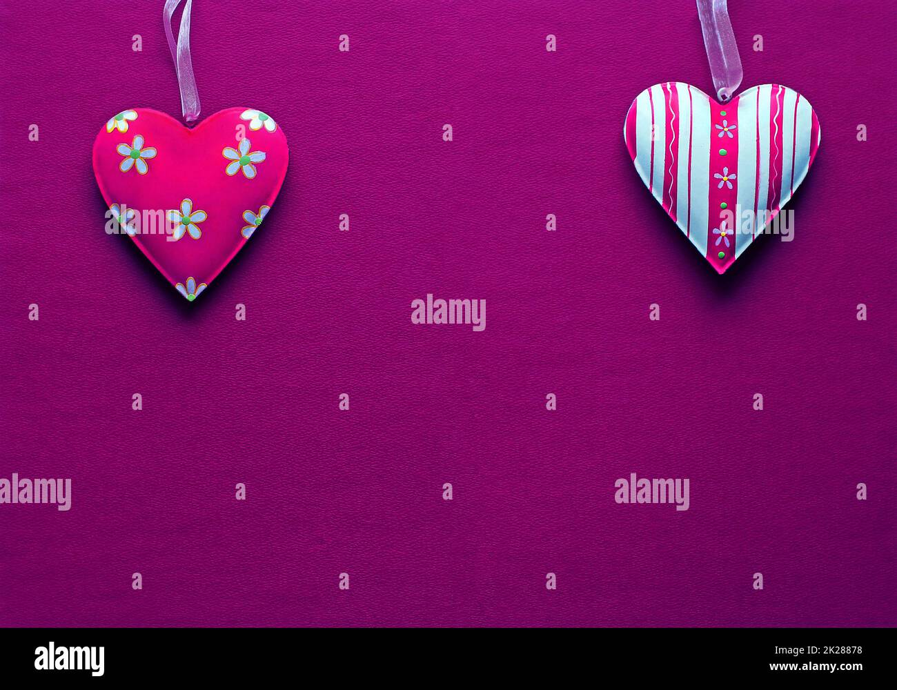 Two white pink metal hearts on a dark pink paper background Stock Photo ...