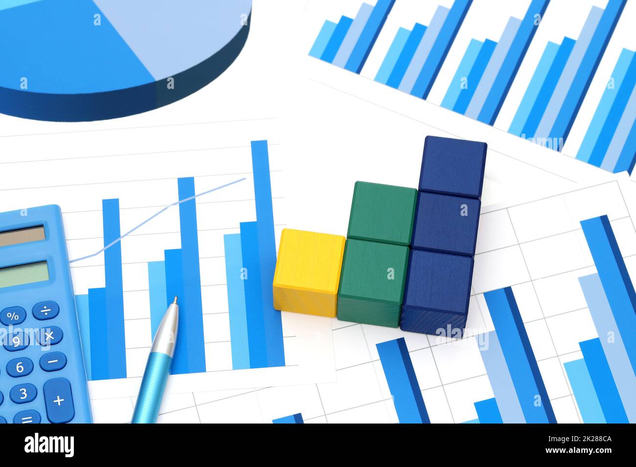 colorful wooden blocks with graph printed documents on white background ...