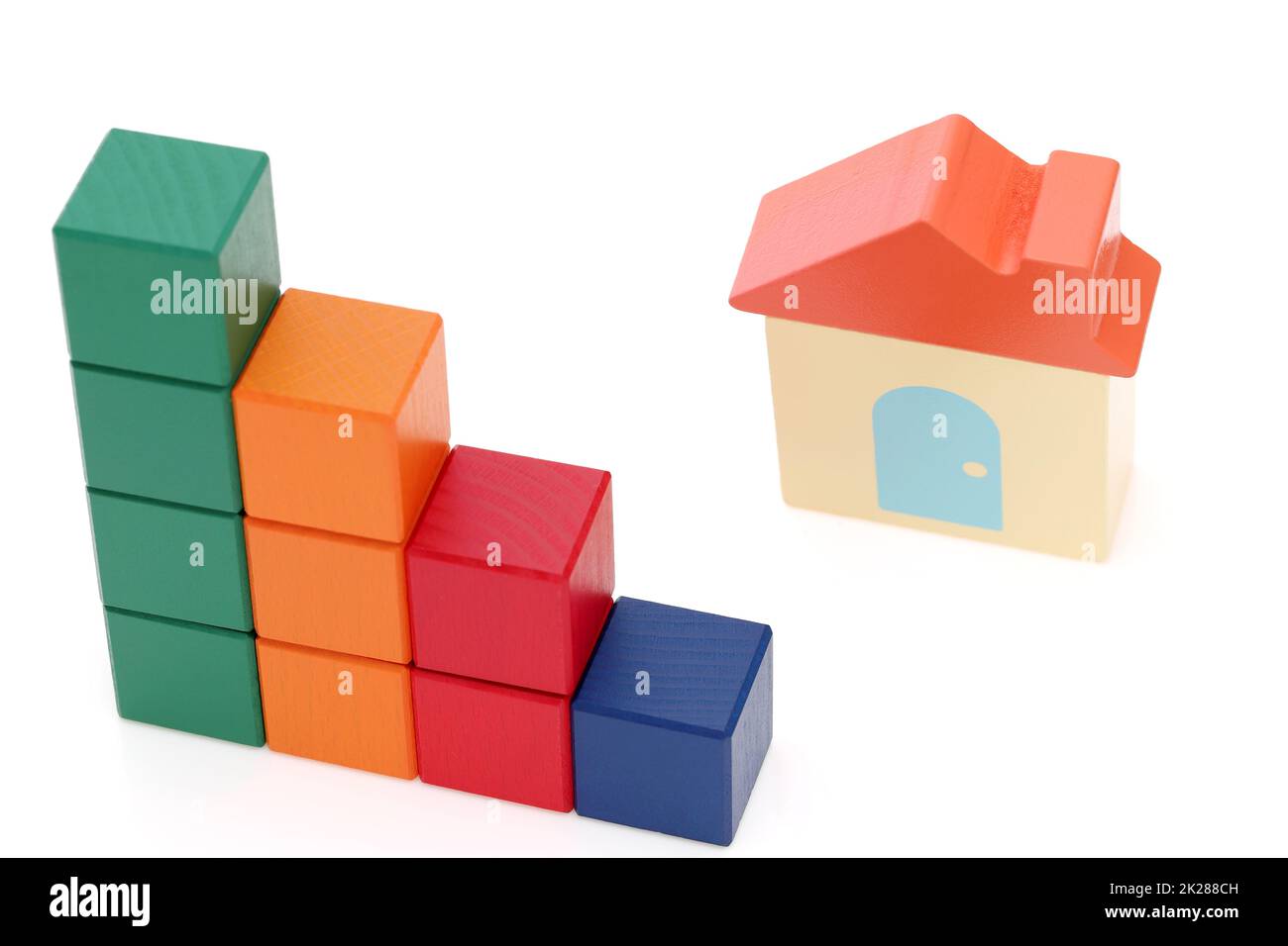 small toy house and wooden colorful building blocks on white background ...
