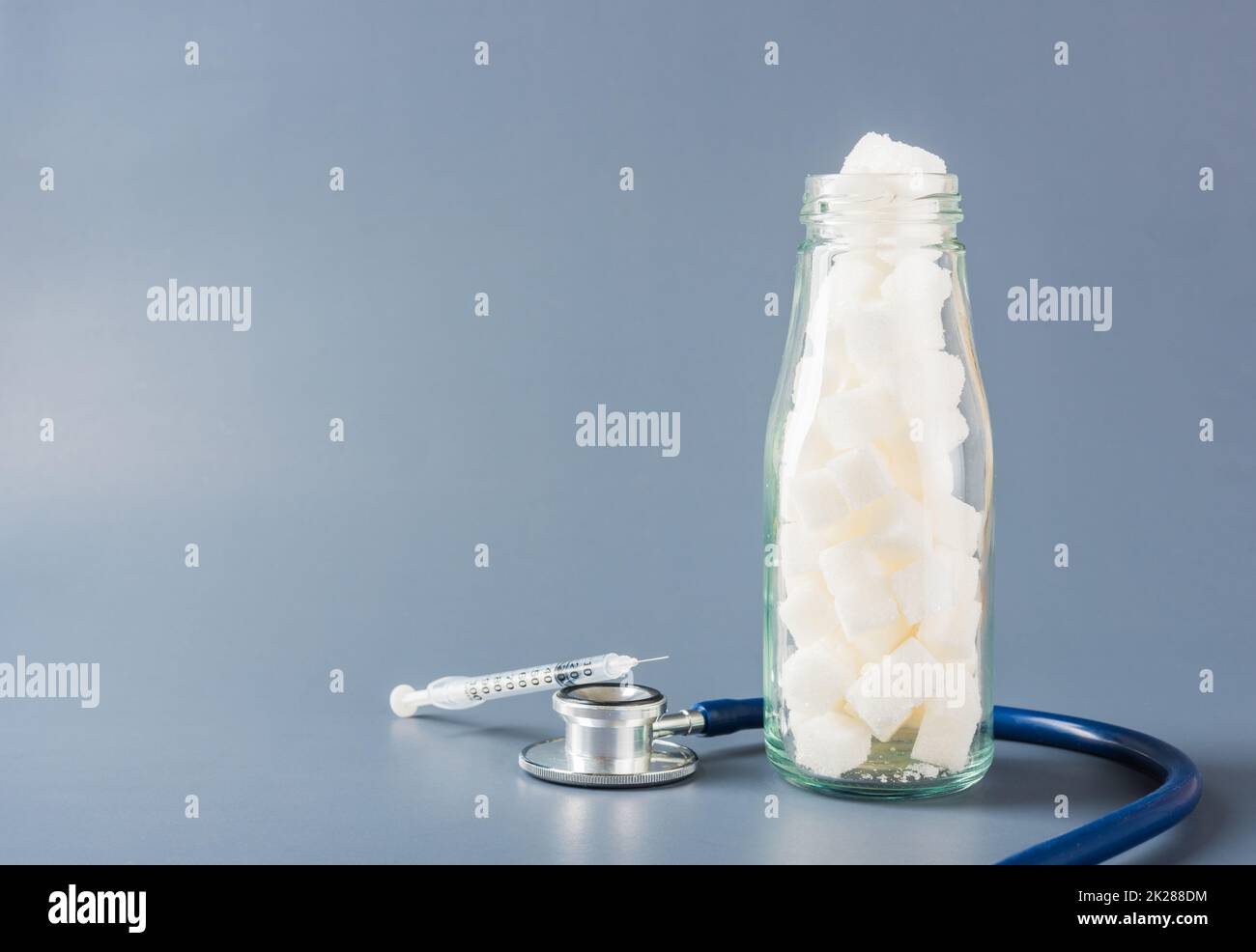 Glass bottle full of white sugar cube Stock Photo - Alamy