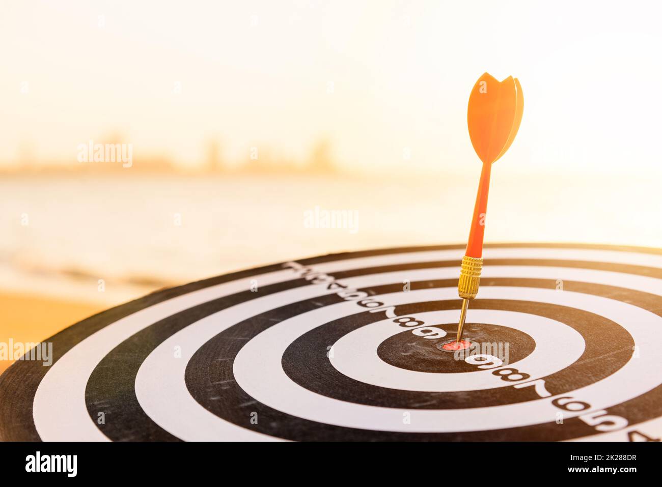 Dart arrow hit center on bullseye dartboard is target Stock Photo - Alamy