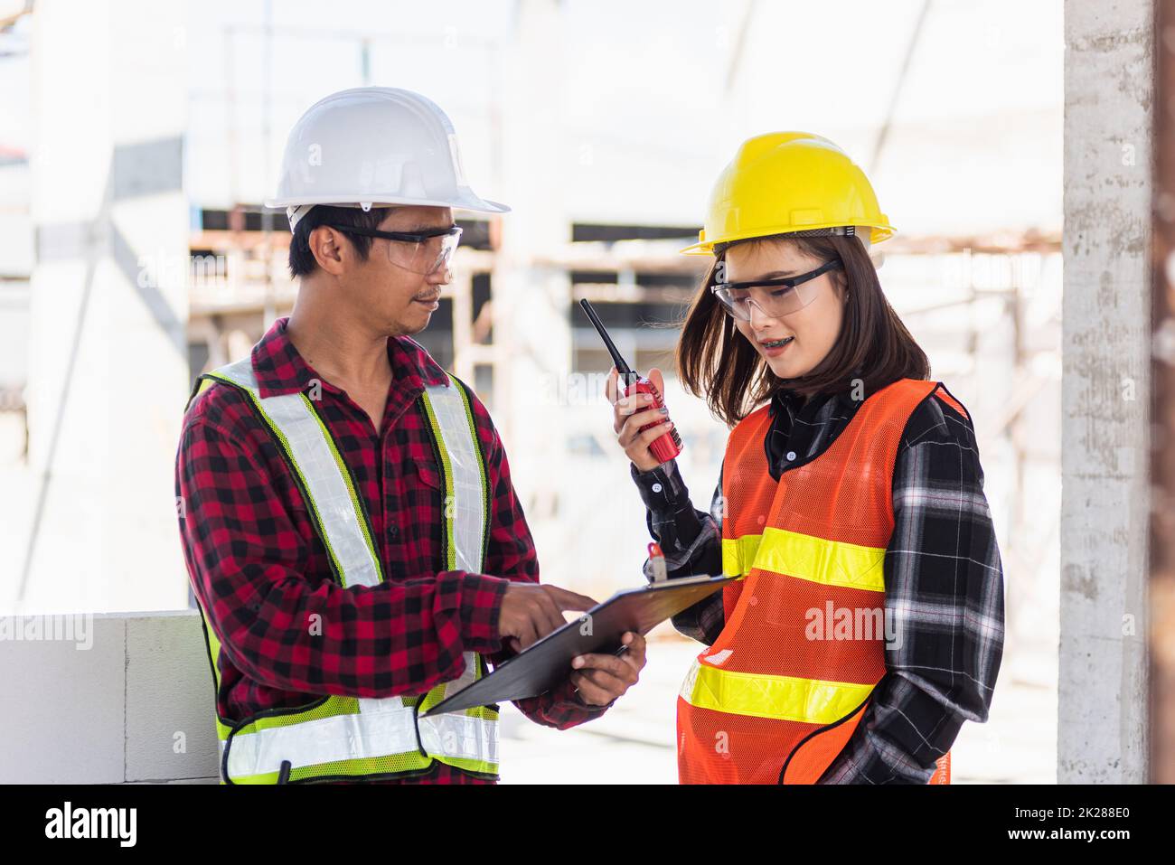 Two Asian engineer foreman architect worker man and woman talking at ...