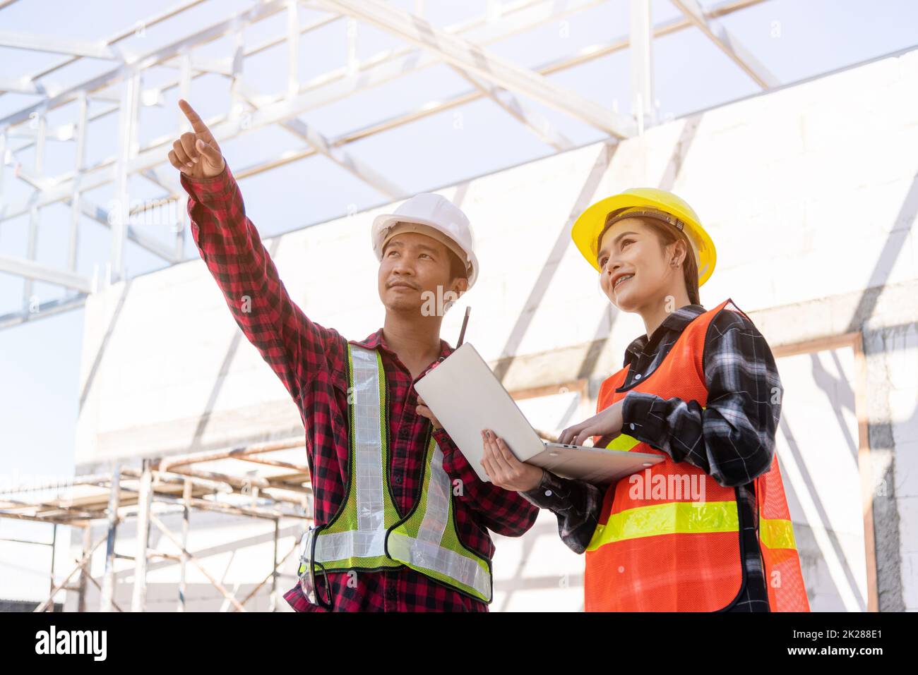 Asian engineer foreman worker man and woman working at building ...