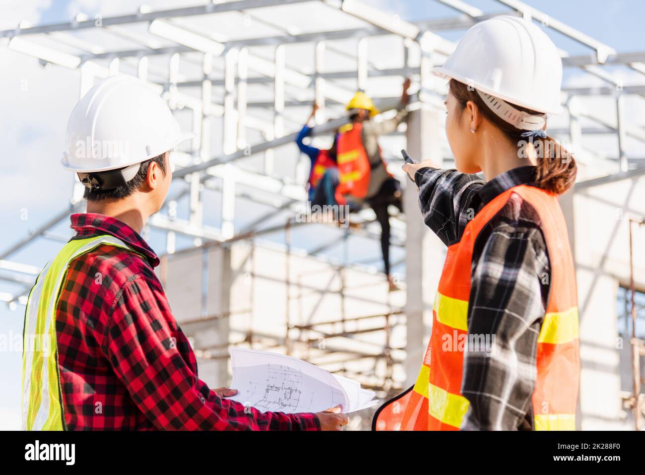 Back two architect and client discussing help create plan with ...