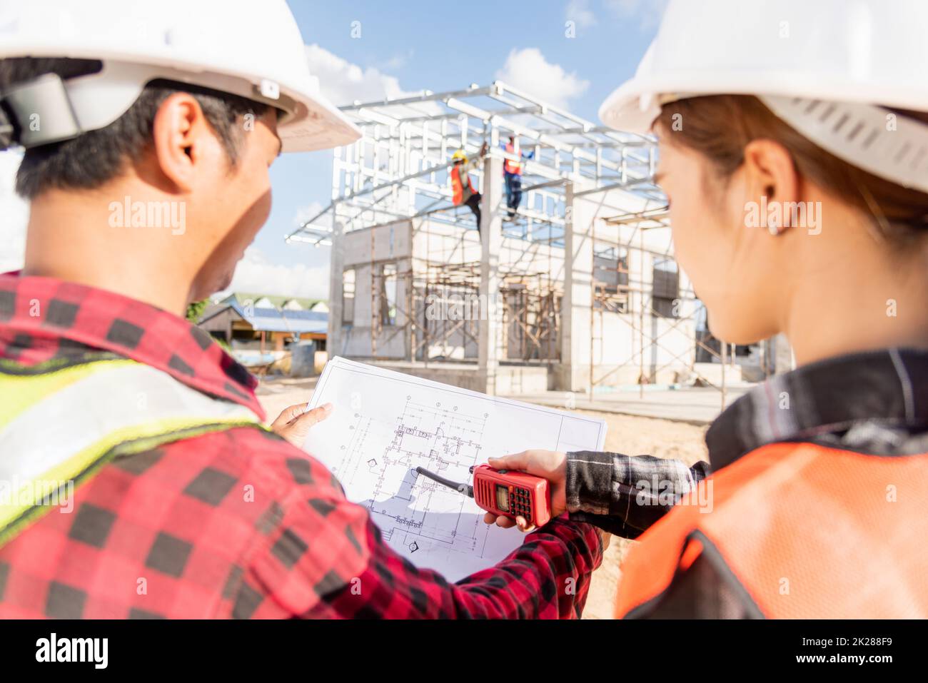 Back two architect and client discussing help create plan with ...