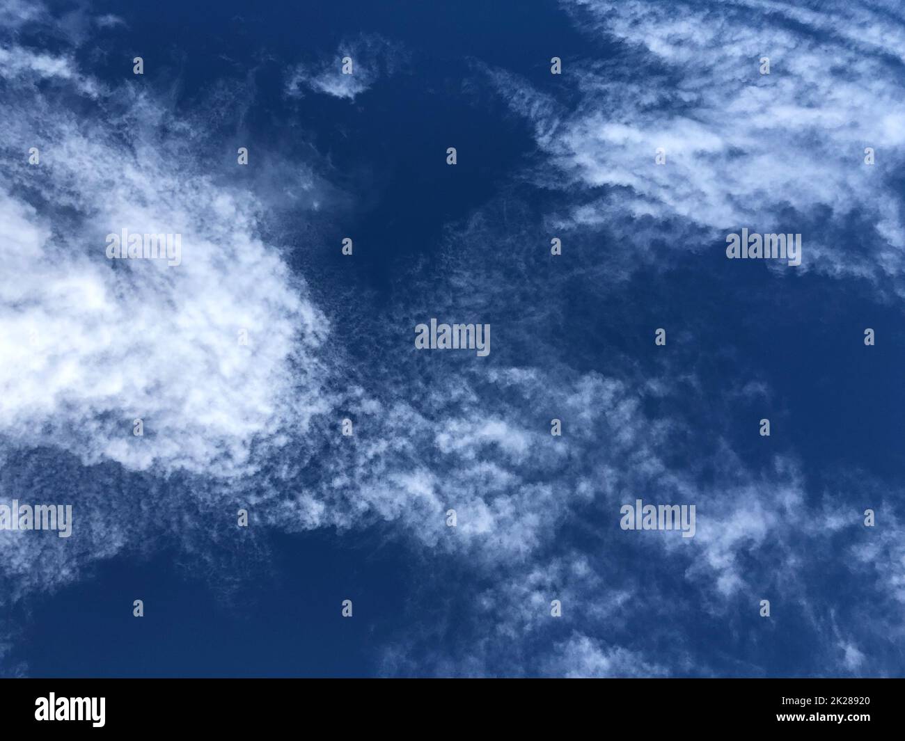 Fluffy white clouds and blue sky Stock Photo - Alamy