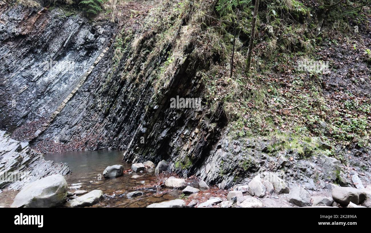 Waterfalls in a small canyon with stone walls. Beautiful cascade in the ...