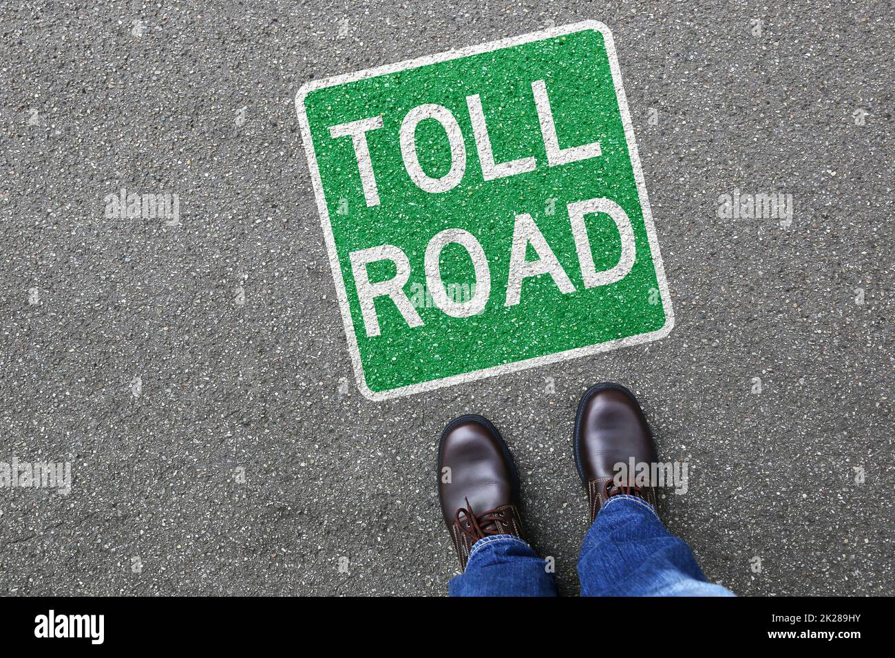 Man people toll road street city town pay paying clean air highway sign ...