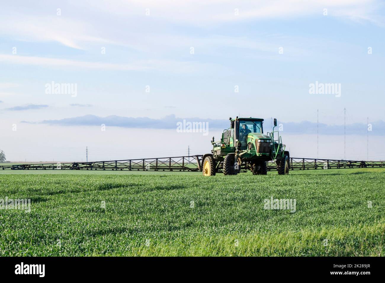 Tractor with a spray device for finely dispersed fertilizer. Tractor on ...