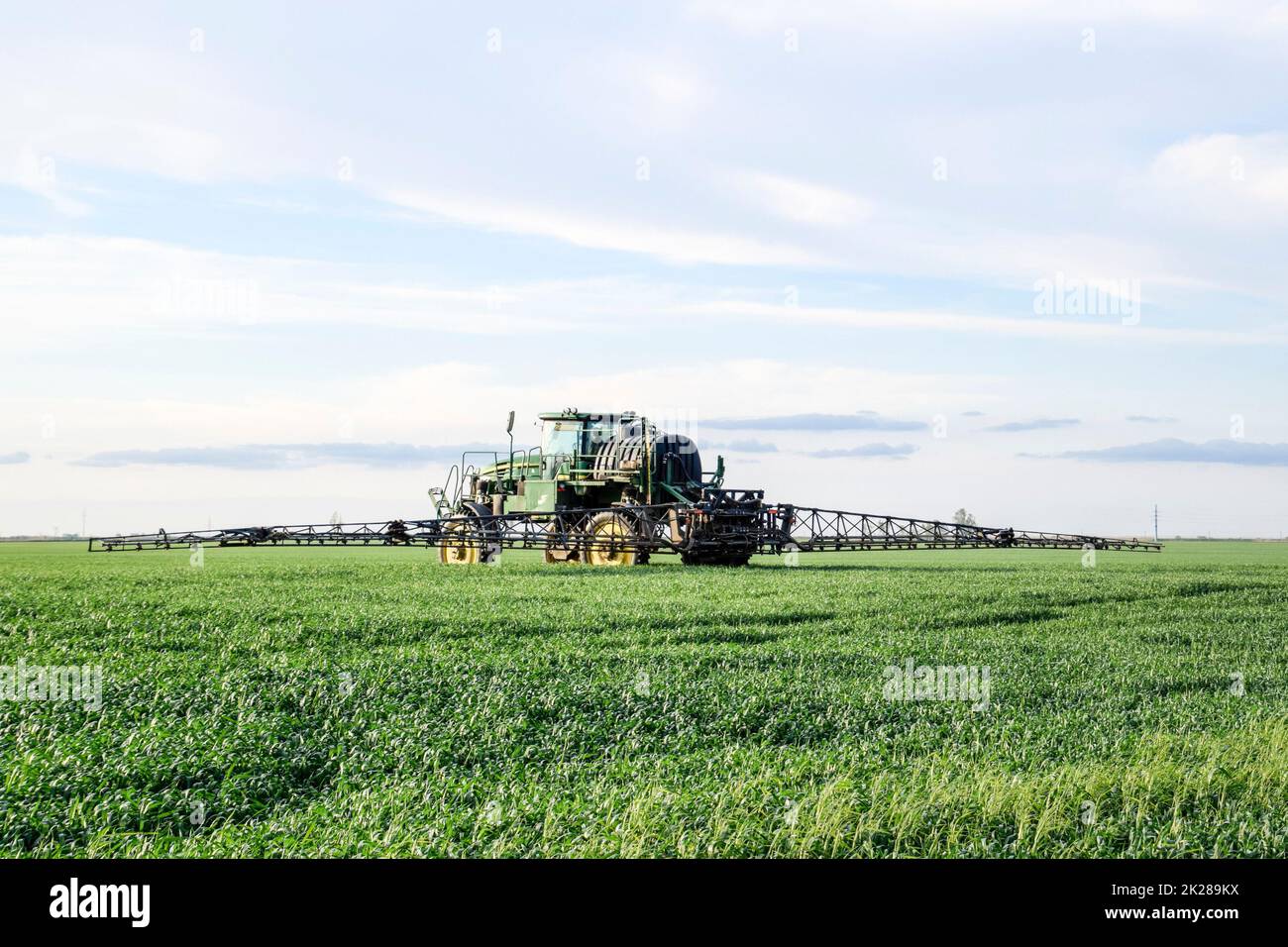 Tractor with a spray device for finely dispersed fertilizer. Tractor on ...