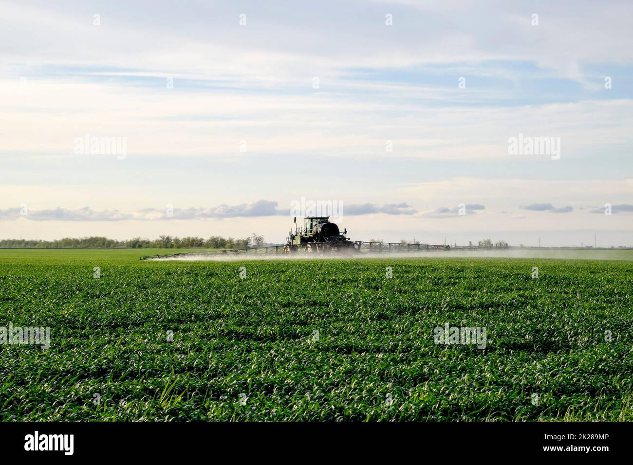 Tractor with a spray device for finely dispersed fertilizer. Tractor on ...