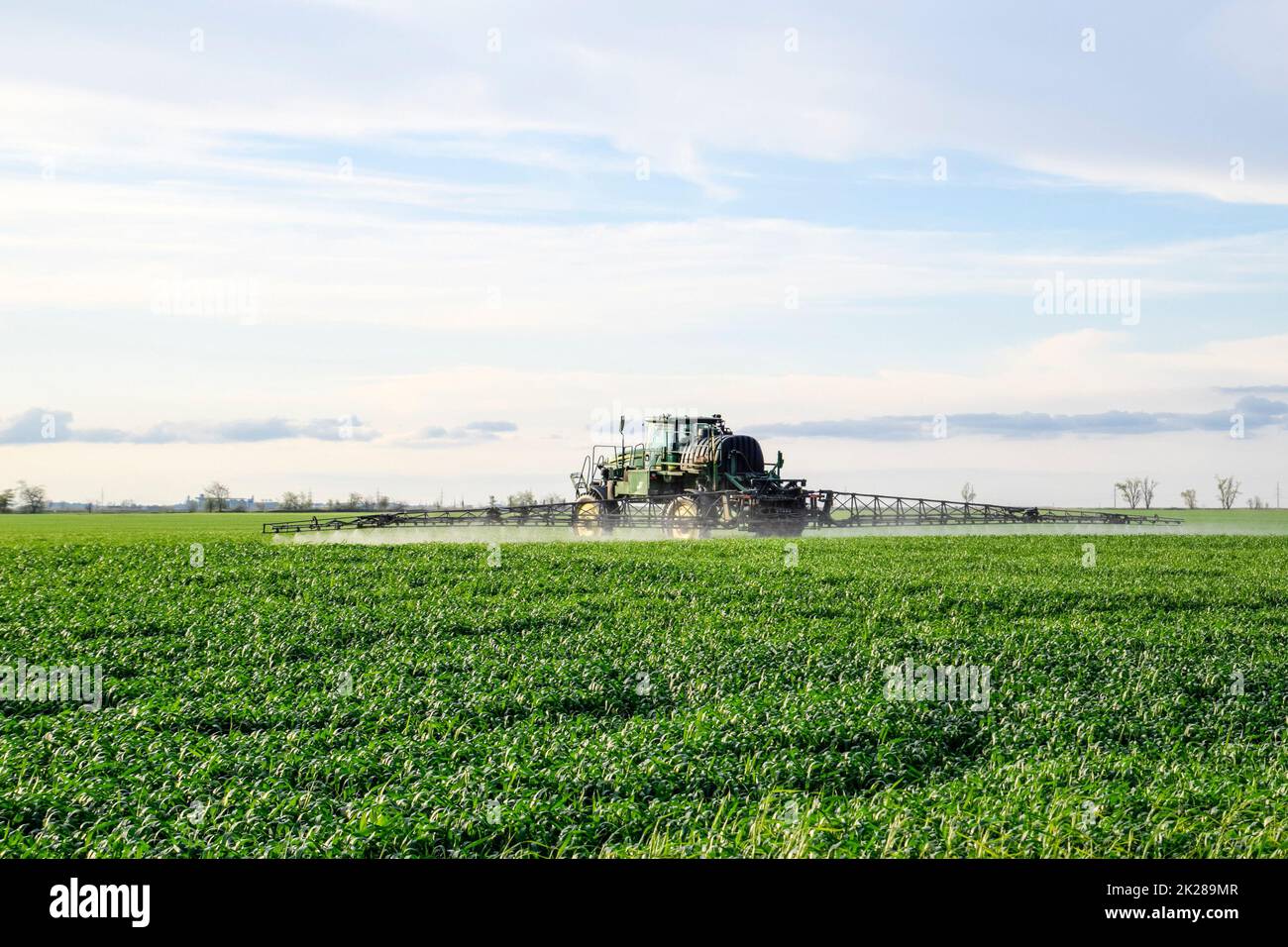 Tractor with a spray device for finely dispersed fertilizer. Tractor on ...